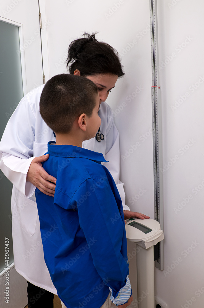 Doctor measuring weight and height of a little child at clinic Stock ...