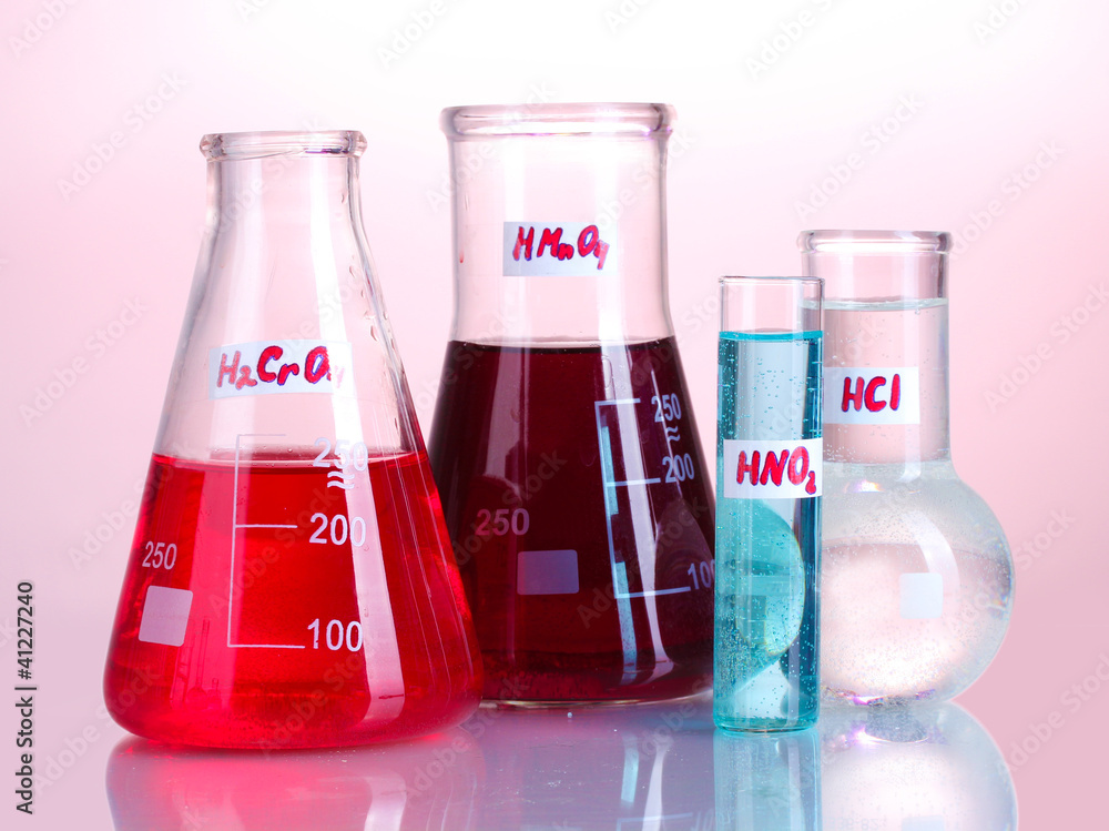 Test-tubes with various acids and chemicals on pink background Stock ...