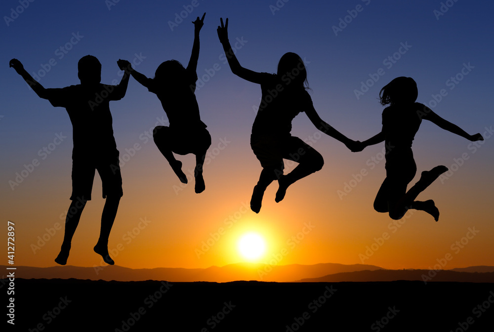 silhouette of kids jumping on beach in sunset Stock Photo | Adobe Stock