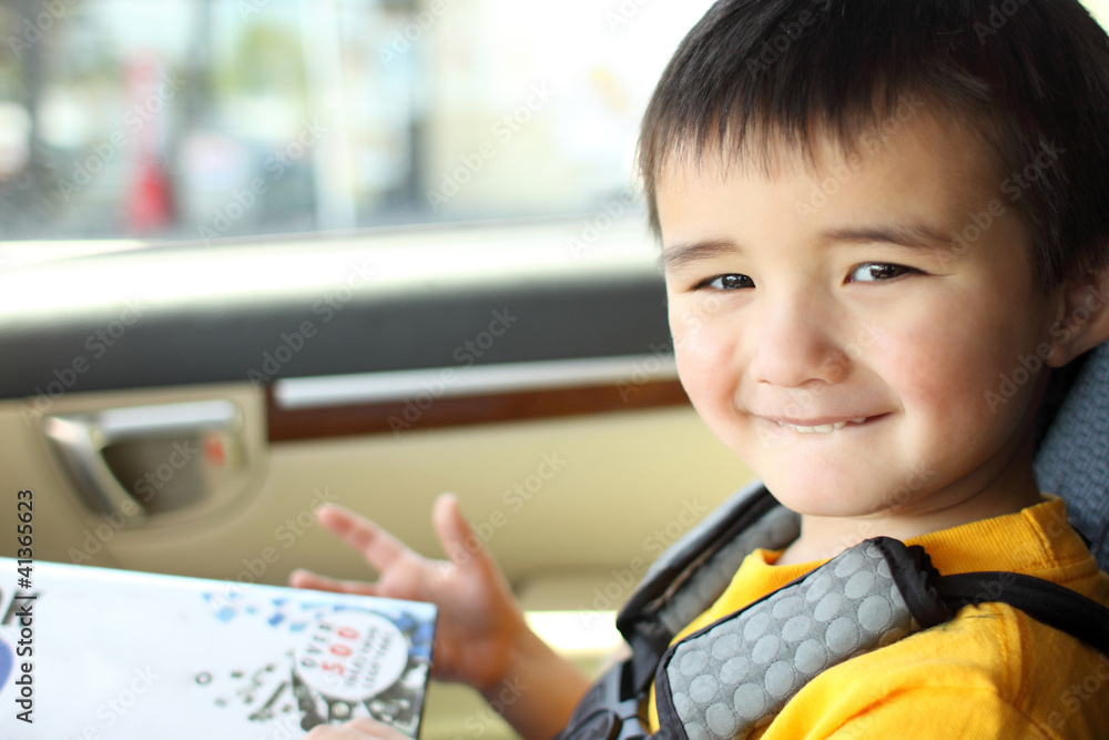 Smiling toddler inside a car. Stock Photo | Adobe Stock