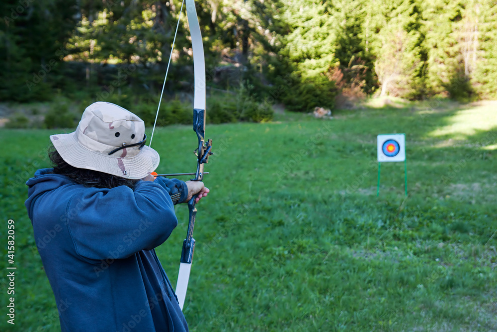 archer with a hat aiming at the target Stock Photo | Adobe Stock