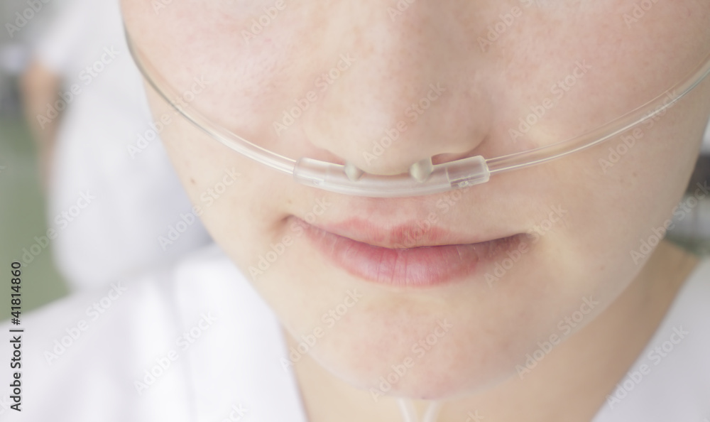 Breathing through a plastic nasal catheter during illness Stock Photo ...
