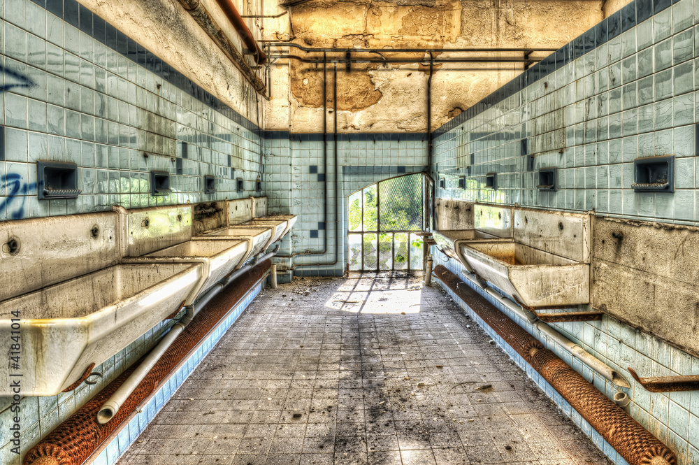 Derelict washbasins in the communal shower room of an abandoned Stock ...