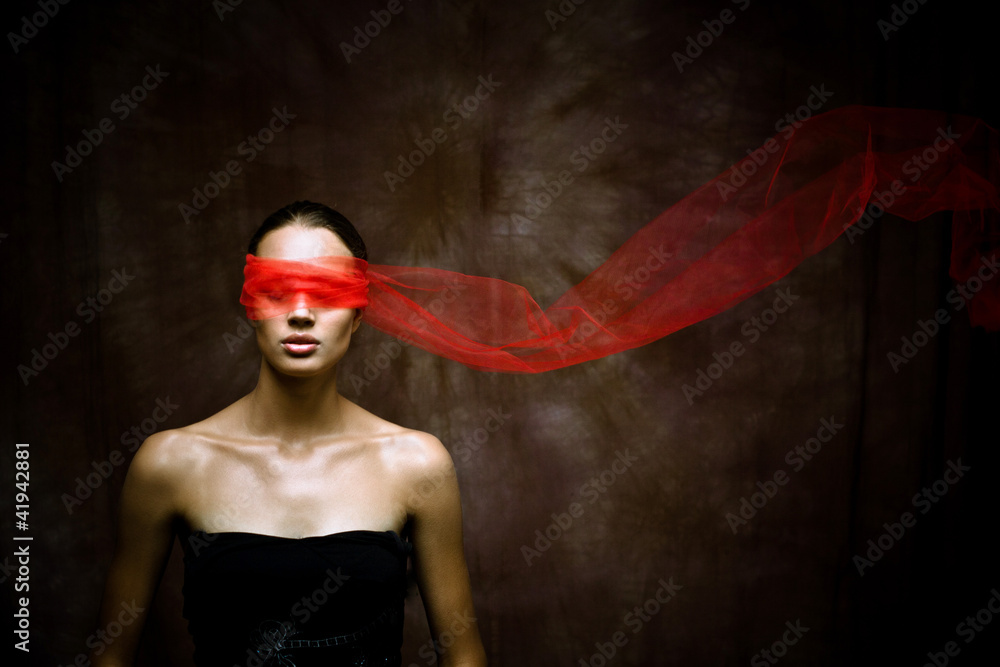 Beauty brunette with red ribbon on eyes Stock Photo | Adobe Stock
