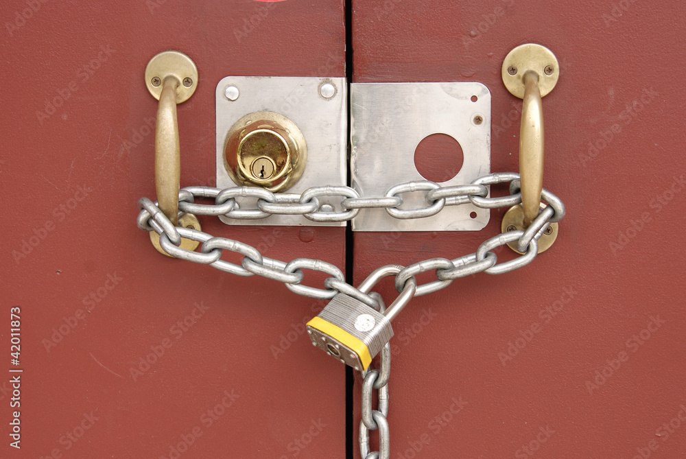 Padlock and chain on commercial doors Stock Photo | Adobe Stock
