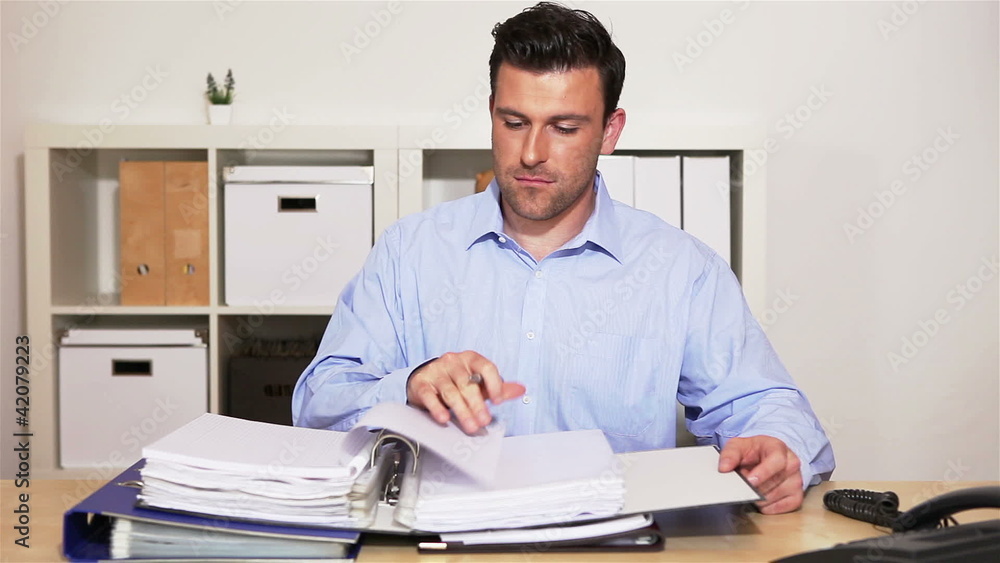 Manager with files at his desk receiving a phone call in his off Stock ...