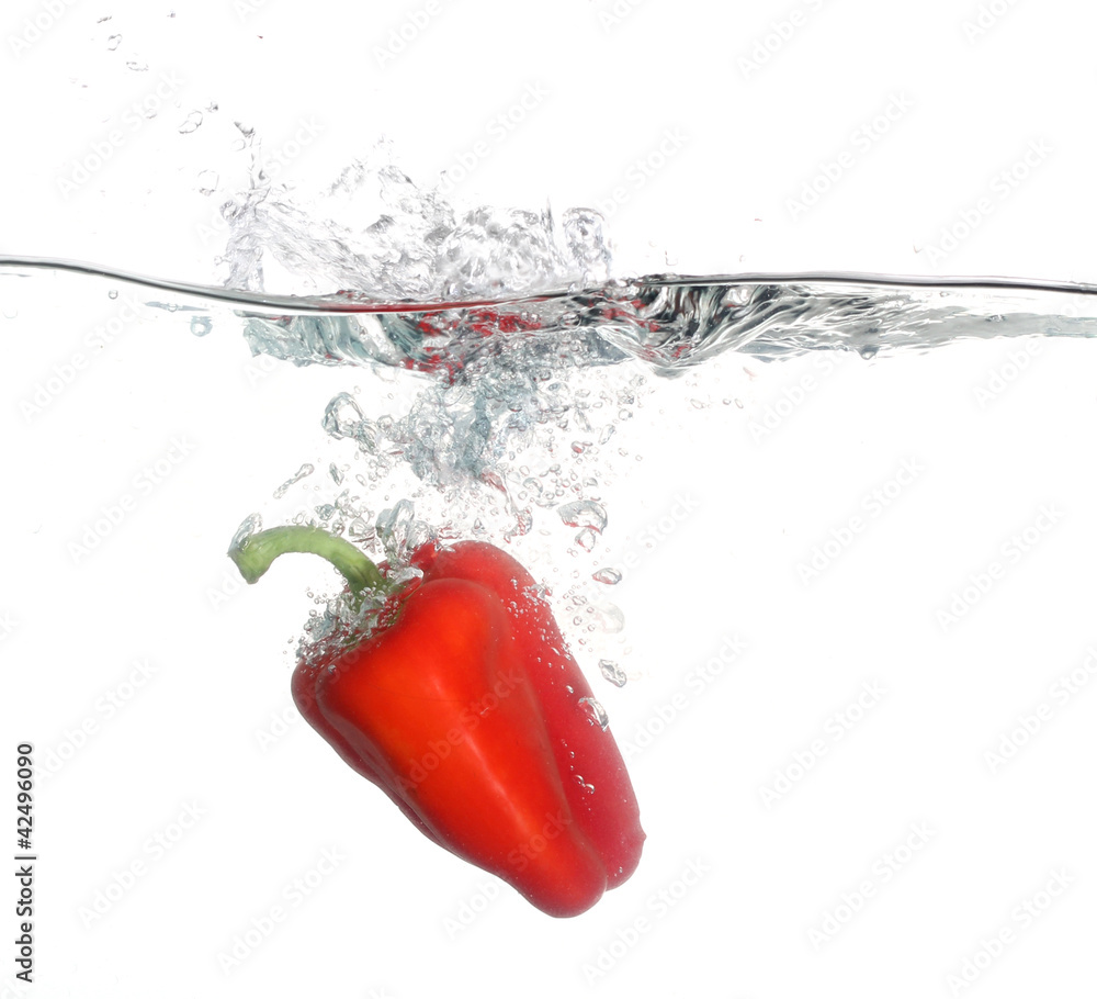 Red pepper falling into water over white background Stock Photo | Adobe ...
