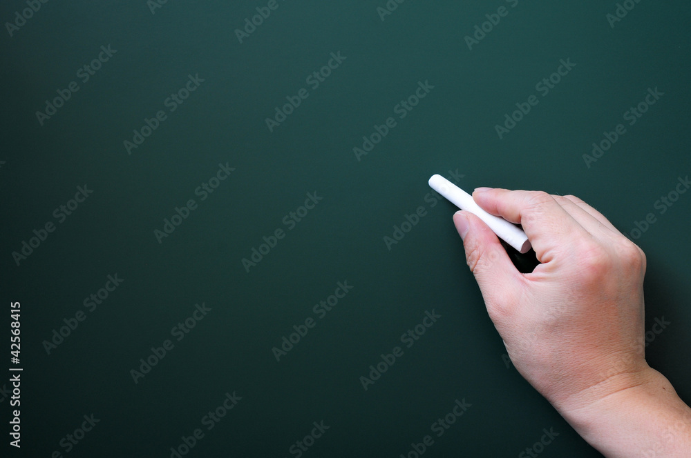 Blackboard background with a hand holding chalk writing. Stock Photo ...