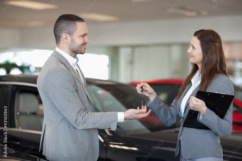 Woman giving car keys to a client Stock Photo | Adobe Stock