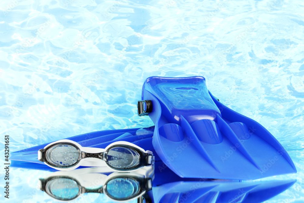 blue flippers and goggles on blue sea background Stock Photo | Adobe Stock