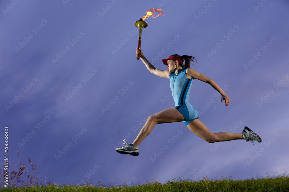 Caucasian athlete running with Olympic torch Stock Photo | Adobe Stock