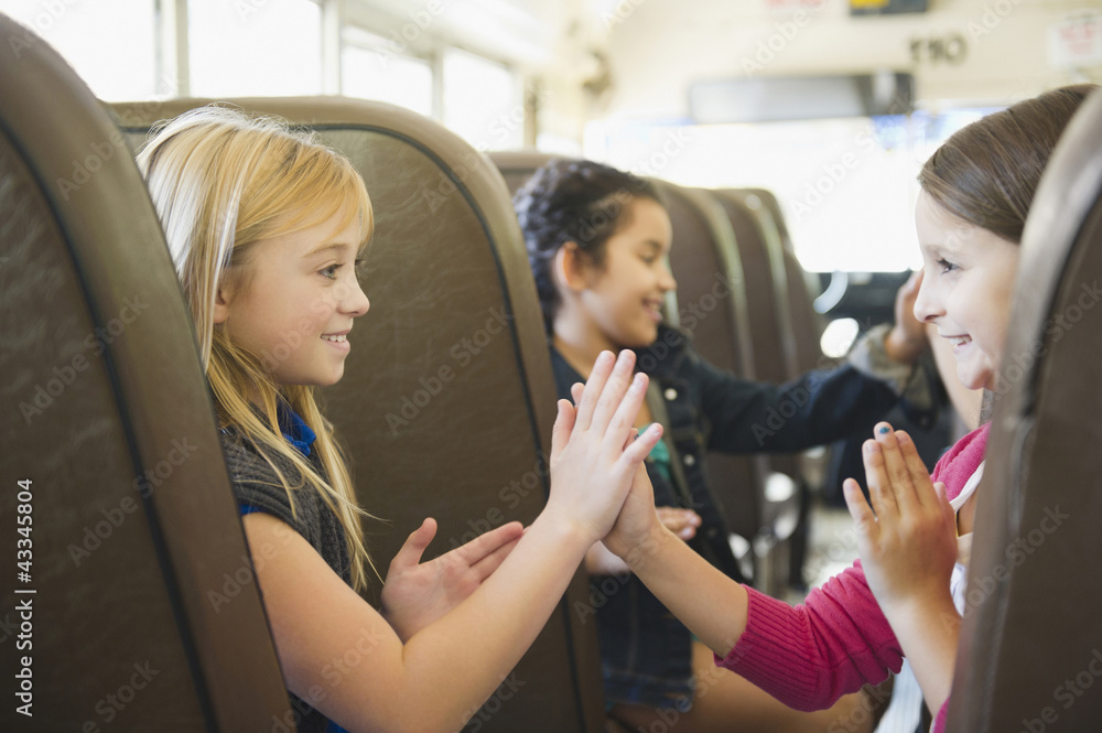 Children playing while riding school bus Stock Photo | Adobe Stock