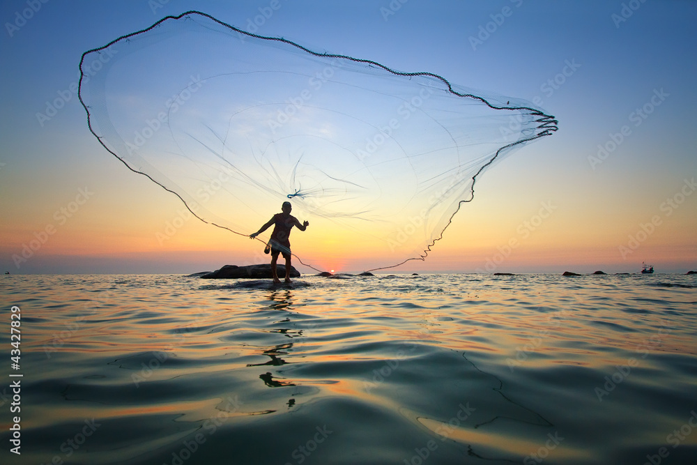 throwing fishing net during sunrise Stock Photo | Adobe Stock