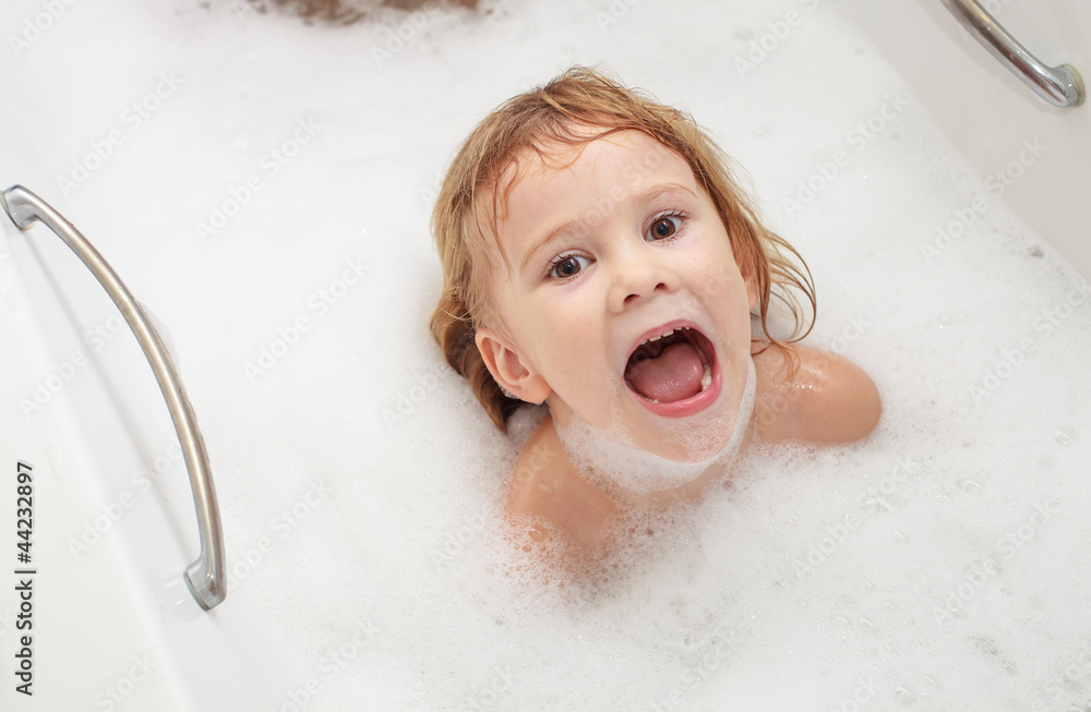 Cute four year old girl taking a relaxing bath with foam. Stock Photo ...