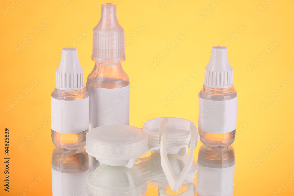Eye drops and lenses on orange background Stock Photo | Adobe Stock
