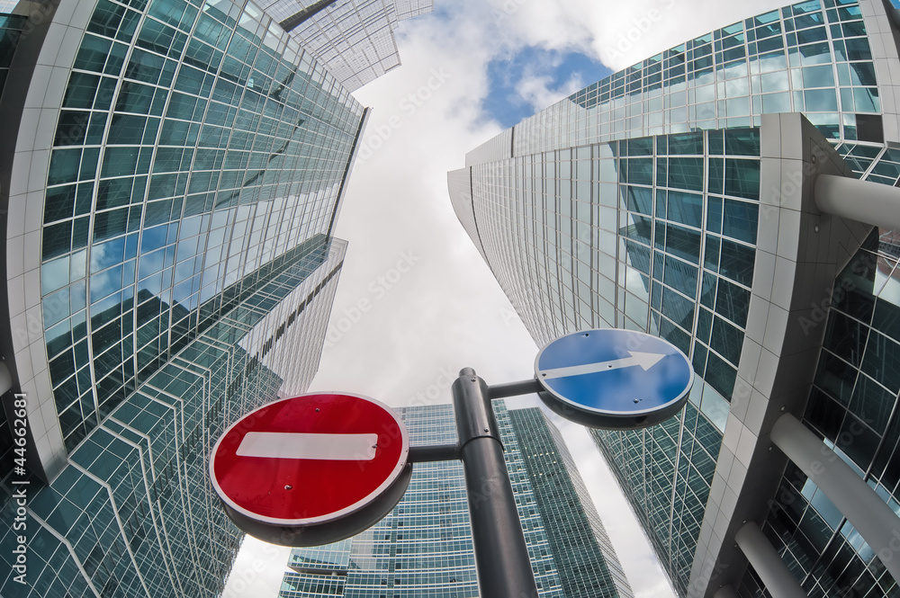 Road signs on the background of office buildings. ภาพถ่ายสต็อก | Adobe ...