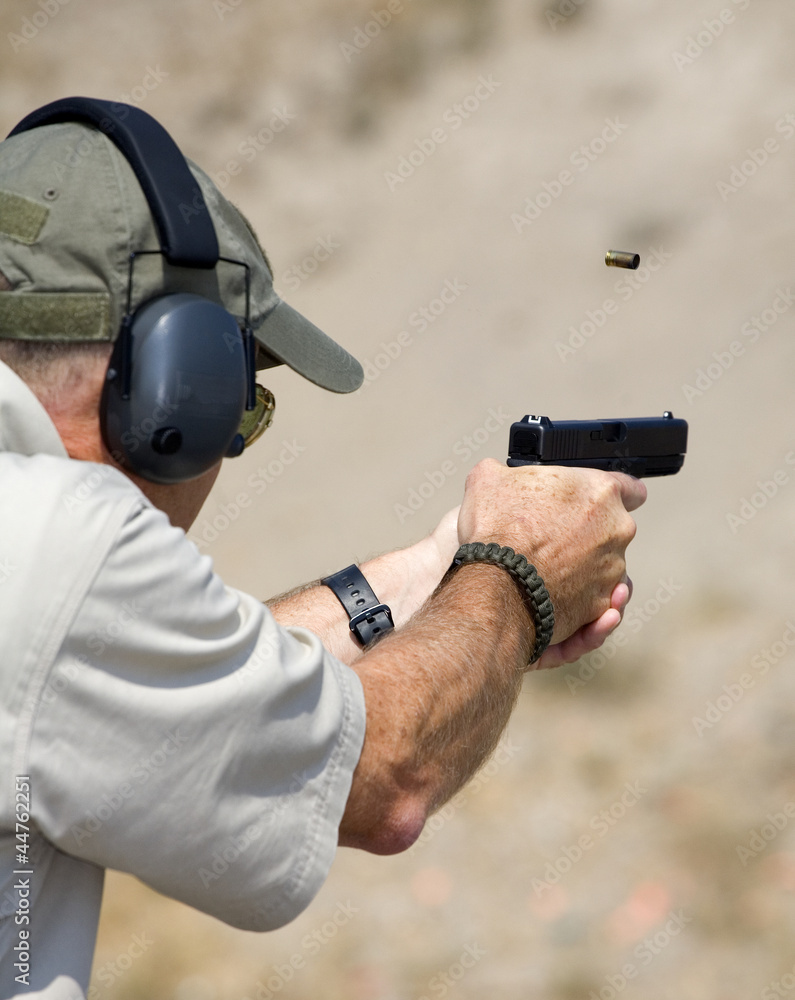 Handgun training at an outdoor range with a semi-automatic pistol ...