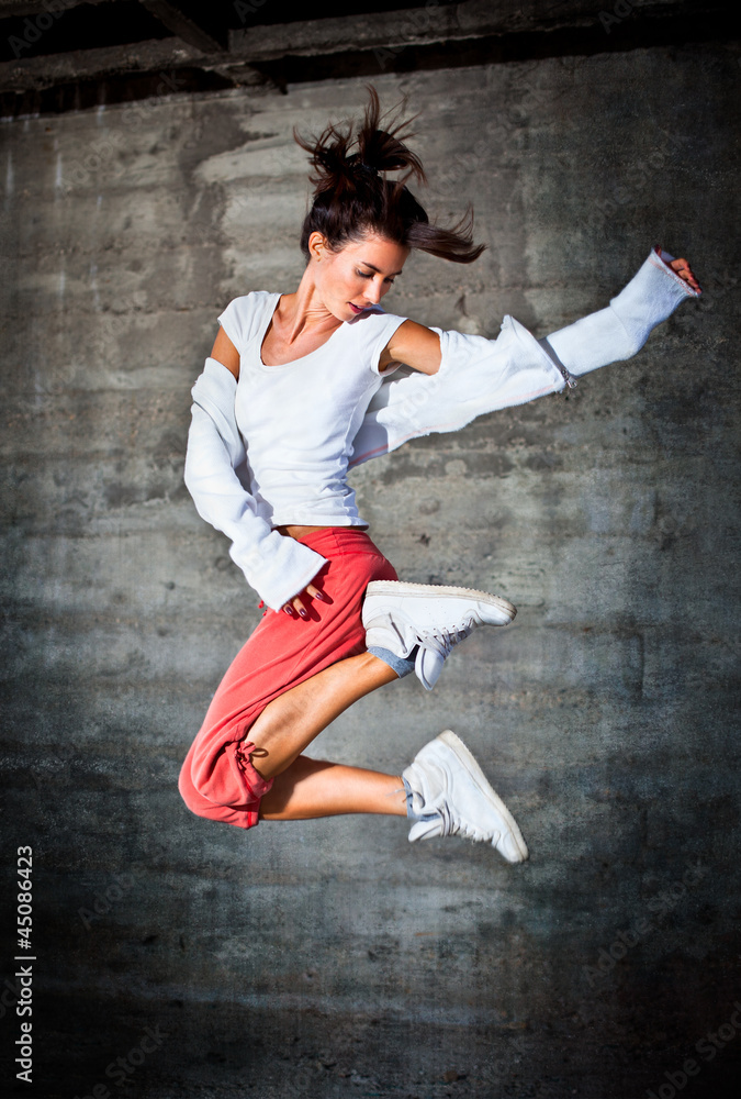 Dancing woman with brown long hair and happy facial expression j Stock ...