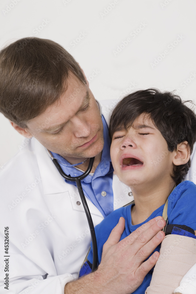 Male doctor in early forties comforting scared patient Stock Photo ...
