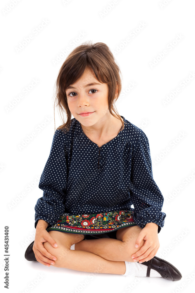 Little girl sitting with crossed legs Stock Photo | Adobe Stock