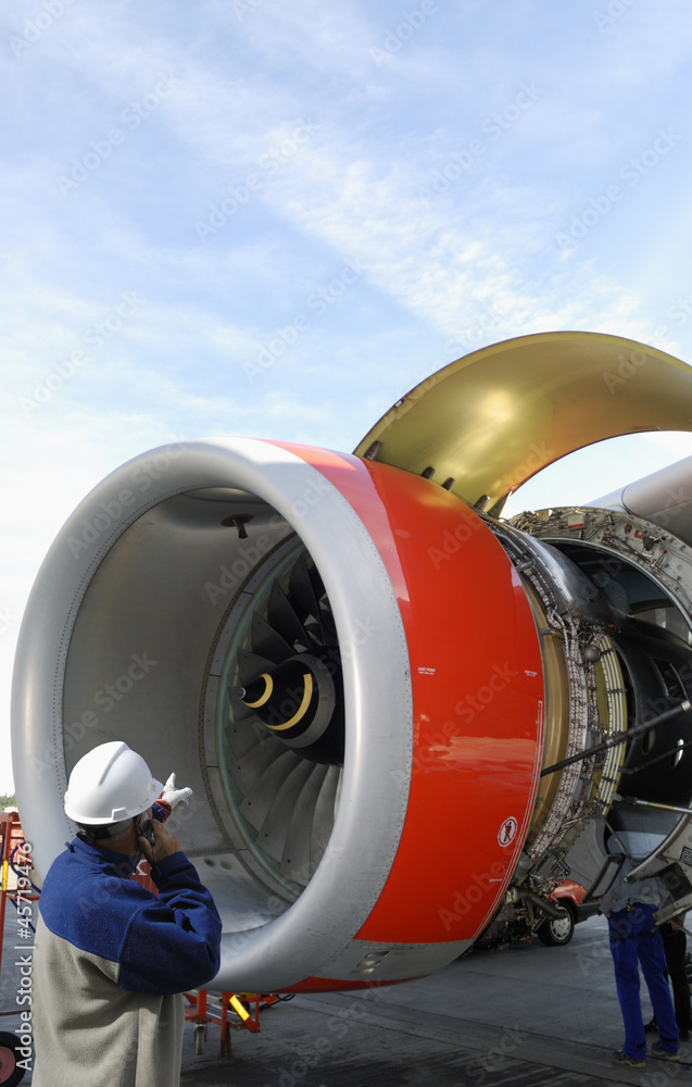 airplane mechanic in front of jet engine Stock Photo | Adobe Stock