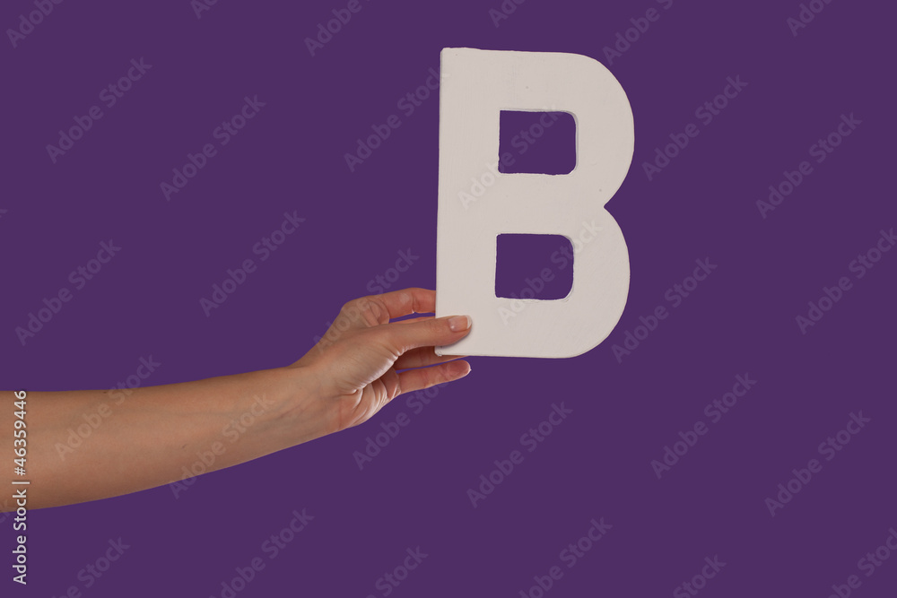 Female hand holding up the letter B from the left Stock Photo | Adobe Stock