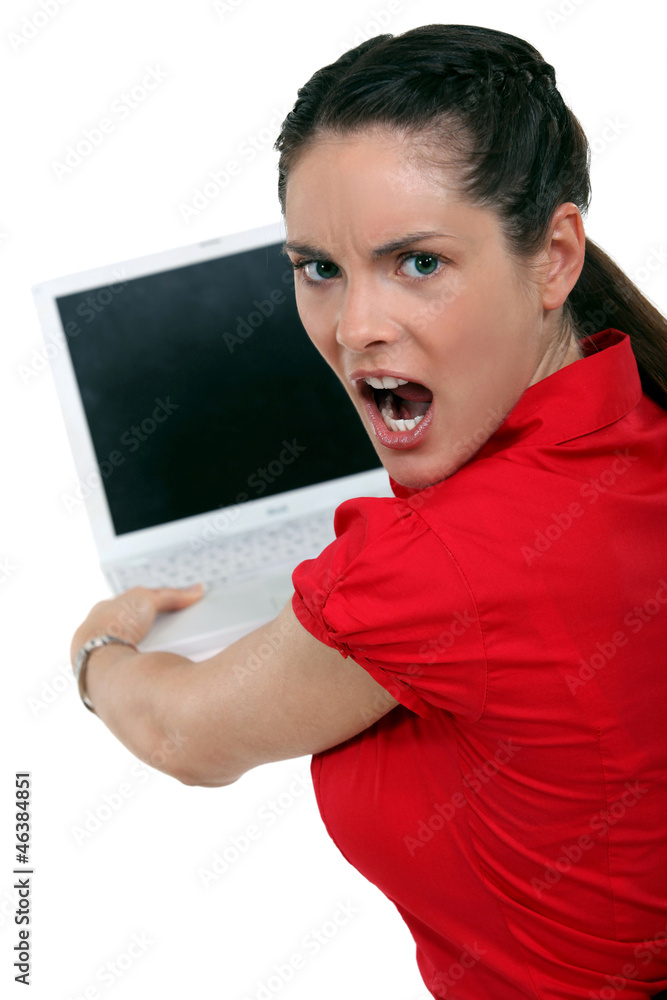 Angry brunette about to smash laptop Stock Photo | Adobe Stock