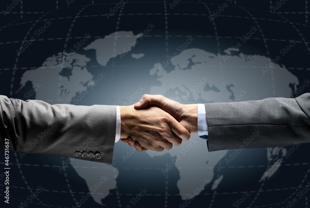 Handshake with map of the world in background Stock Photo | Adobe Stock