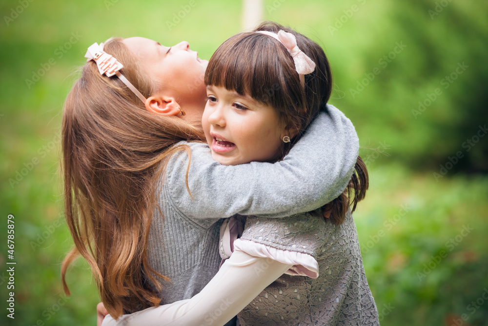 Happy little girlfriends in park Stock Photo | Adobe Stock