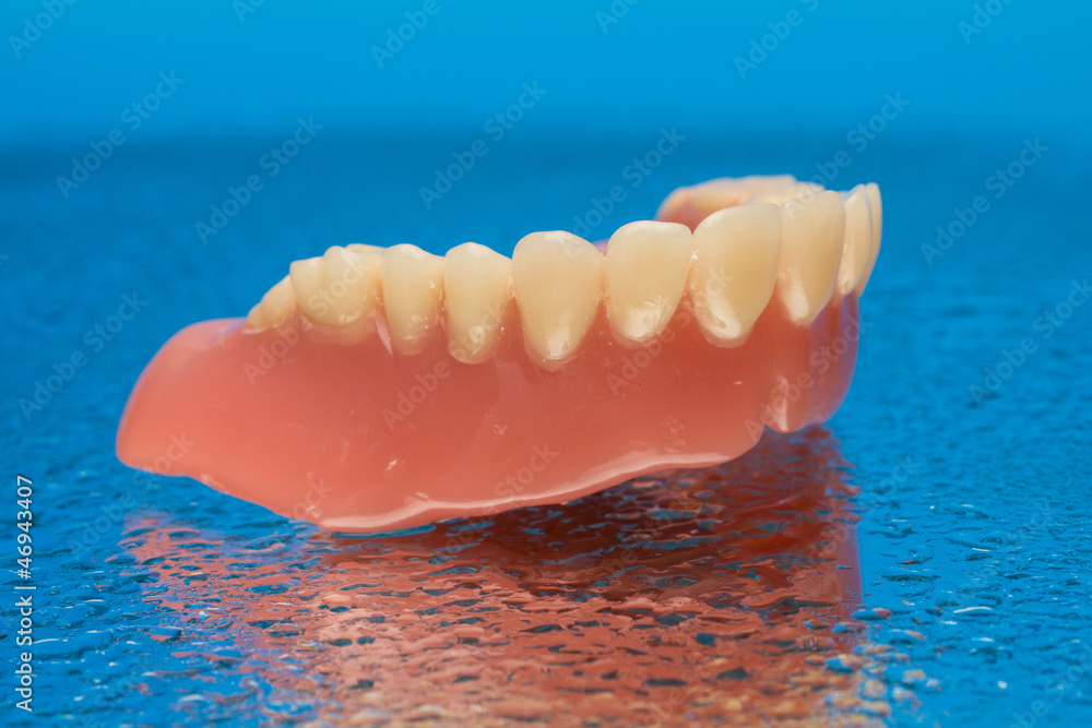 Zahnvollprothese auf blauem wassertropfen Stock-Foto | Adobe Stock