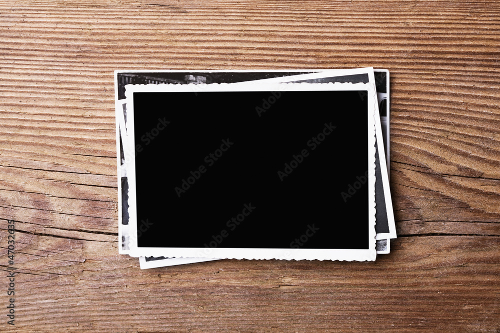 Stack of old photos on wooden background Stock Photo | Adobe Stock