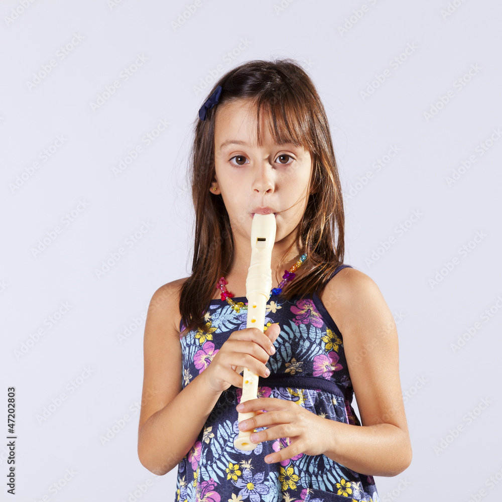 Little girl playing flute Stock Photo | Adobe Stock