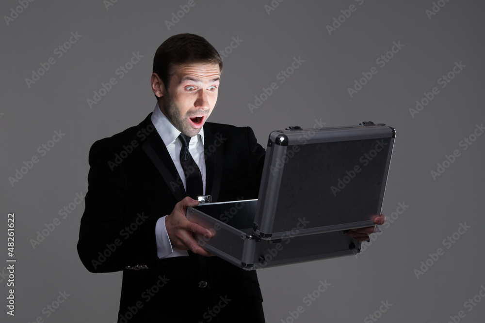 Surprised businessman opening his briefcase Stock Photo | Adobe Stock