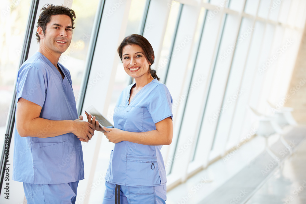 Medical Staff Talking In Hospital Corridor With Digital Tablet Stock ...