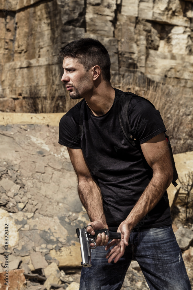menacing man reloading a handgun Stock Photo | Adobe Stock