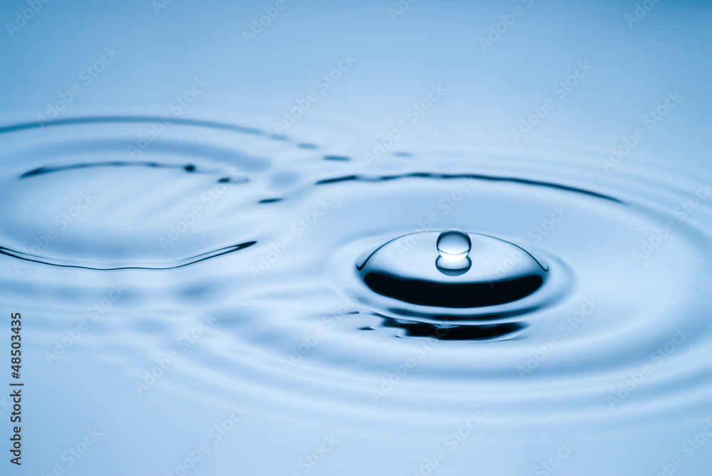 Water drop falling into water making a perfect droplet splash Stock ...