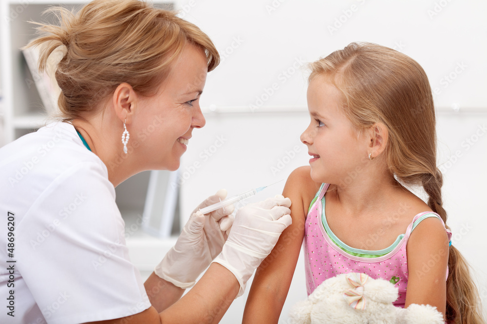 Brave little girl receiving injection Stock Photo | Adobe Stock
