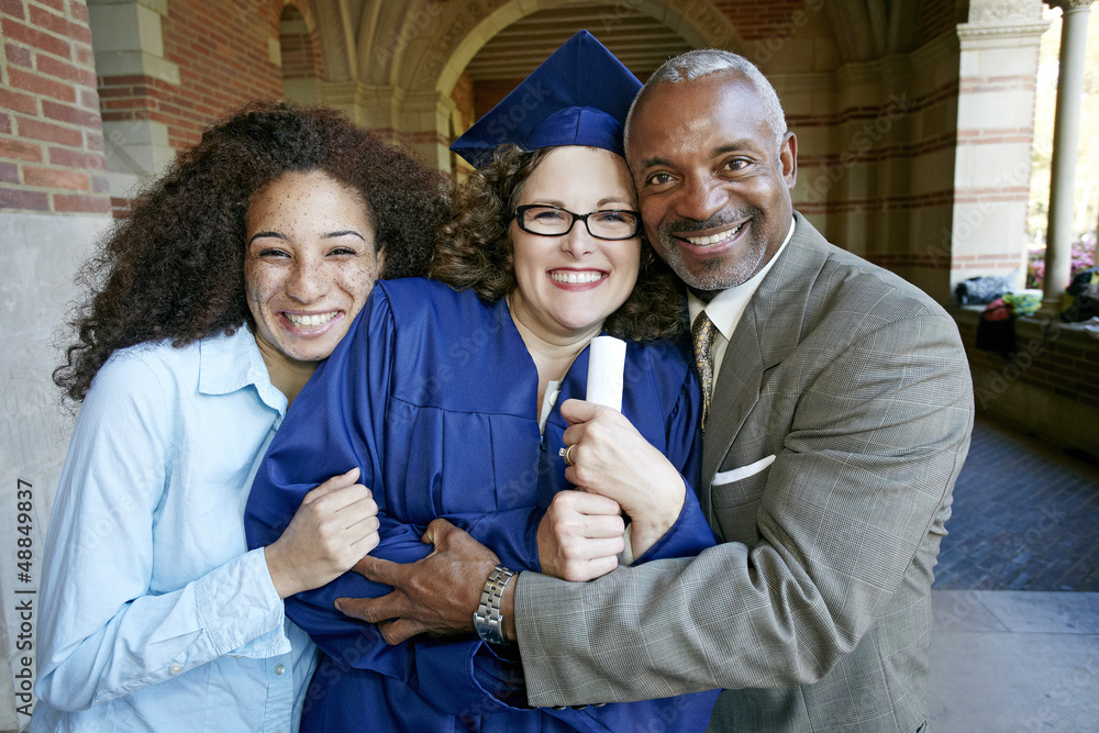 Proud family hugging graduate Stock Photo | Adobe Stock