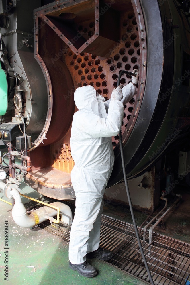 An engineer wearing ppe for an industrial boiler clean Stock Photo ...