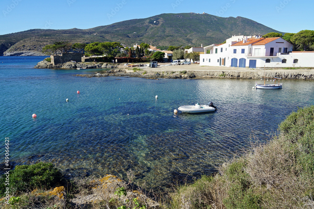 Cove with boats on mooring buoys and a waterfront house, village of ...