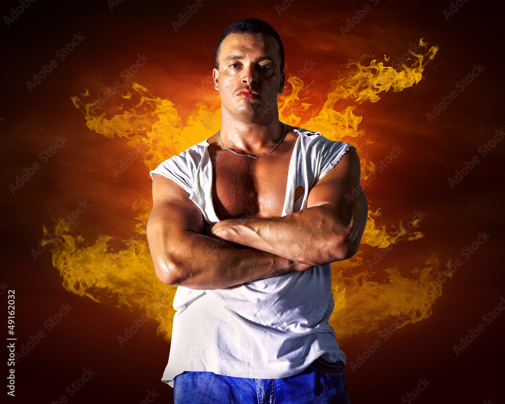 Bodybuilder posing on the fire flames background Stock Photo | Adobe Stock