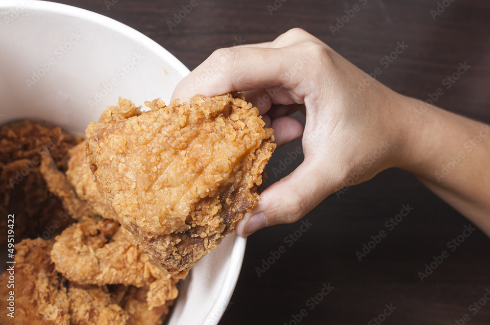 hand picking up fried chicken Stock Photo | Adobe Stock