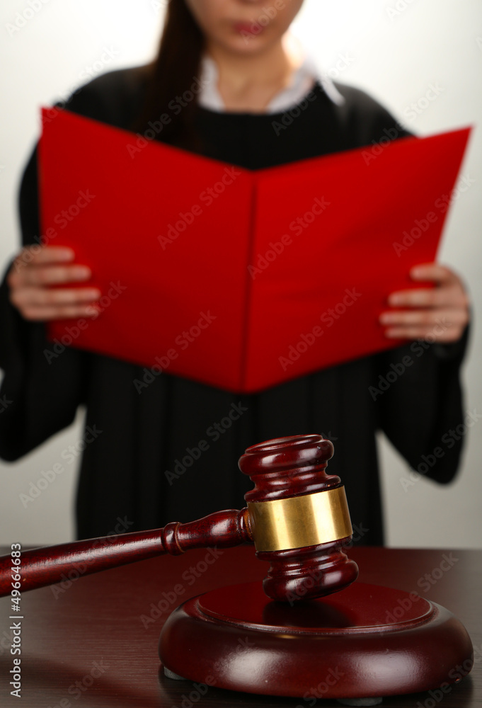 Judge read verdict on grey background Stock Photo | Adobe Stock