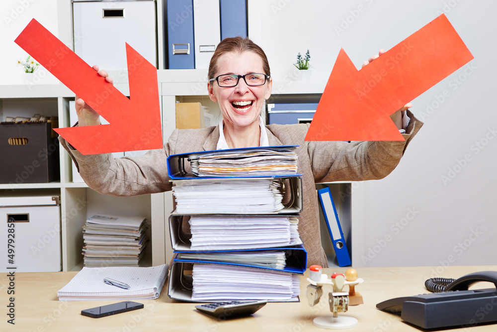 Frau im Büro zeigt mit Pfeilen auf Stapel Akten Stock-Foto | Adobe Stock