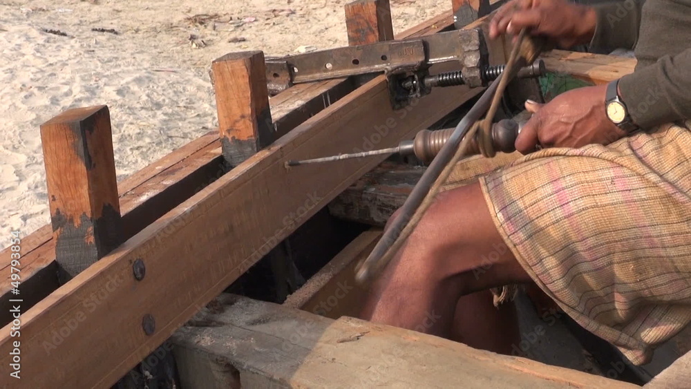 indian worker with primitive drill drilling new boat wood Stock Video ...