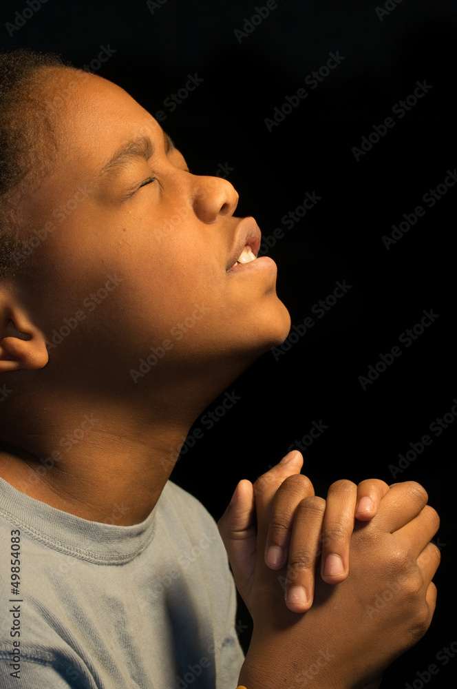 Praying African American boy Stock Photo | Adobe Stock