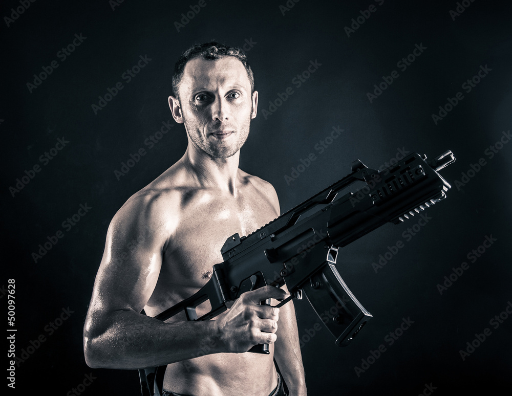 Confident young man shirtless portrait with machine gun Stock Photo ...
