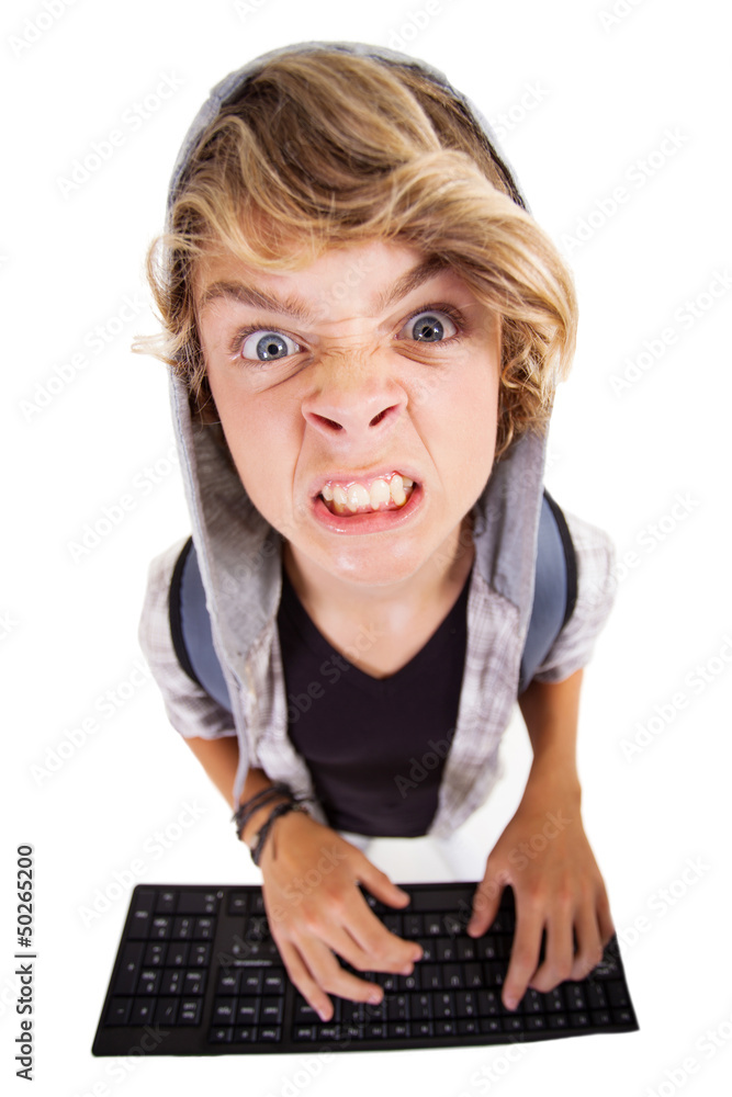overhead view of angry teen boy playing on computer keyboard Stock ...