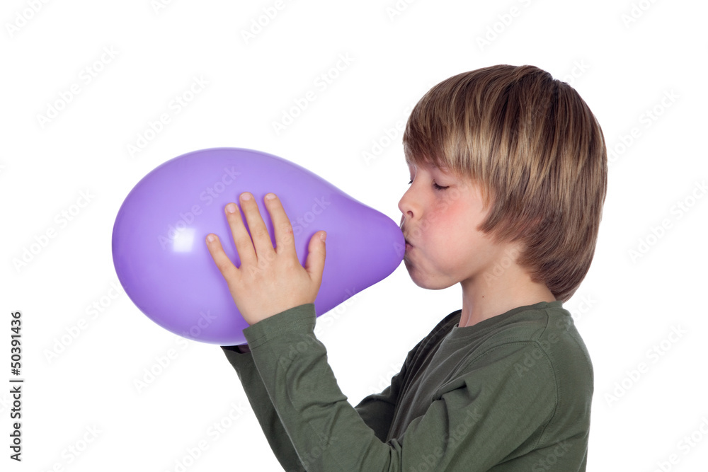 Adorable preteen boy blowing up a purple balloon Stock Photo | Adobe Stock