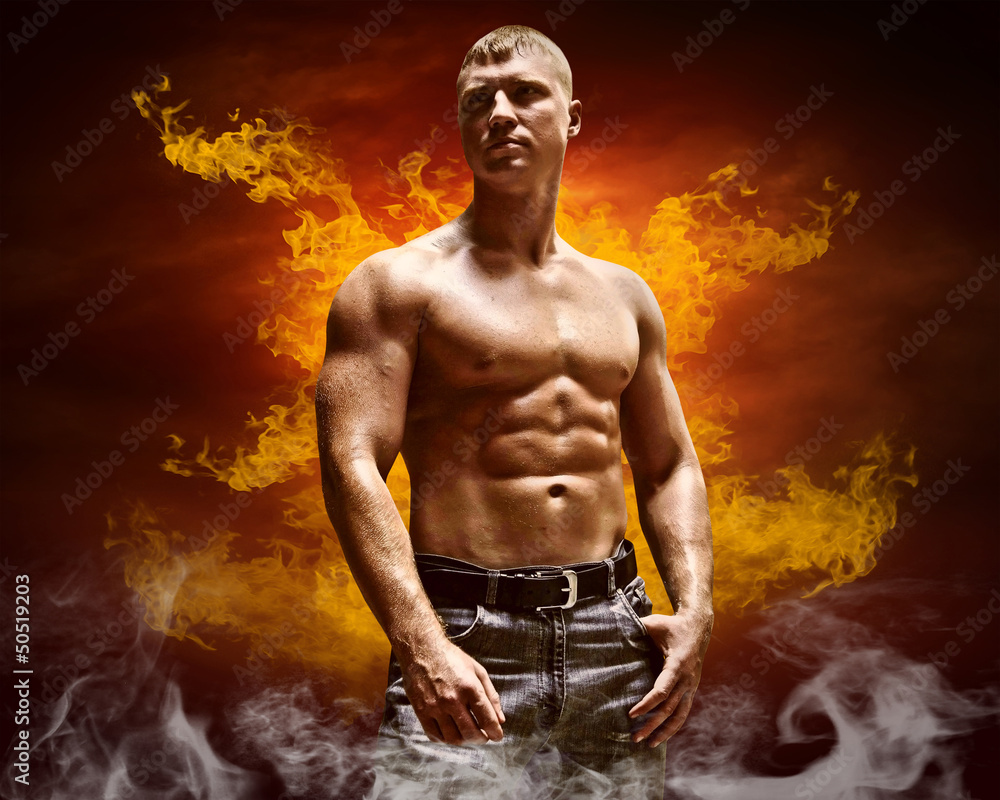 Bodybuilder posing on the fire flames background Stock Photo | Adobe Stock